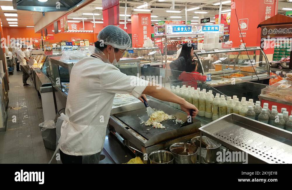 Chef prepares fresh food in Walmart supermarket and department store in ...