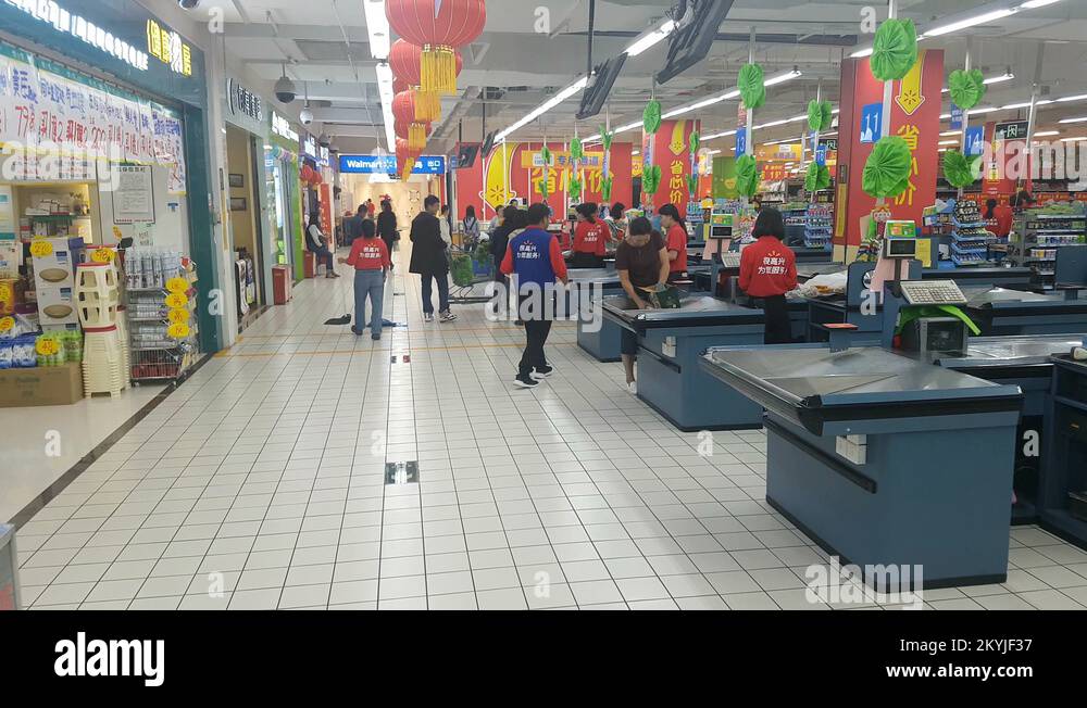 Walking past cash registers of Walmart supermarket and department store ...