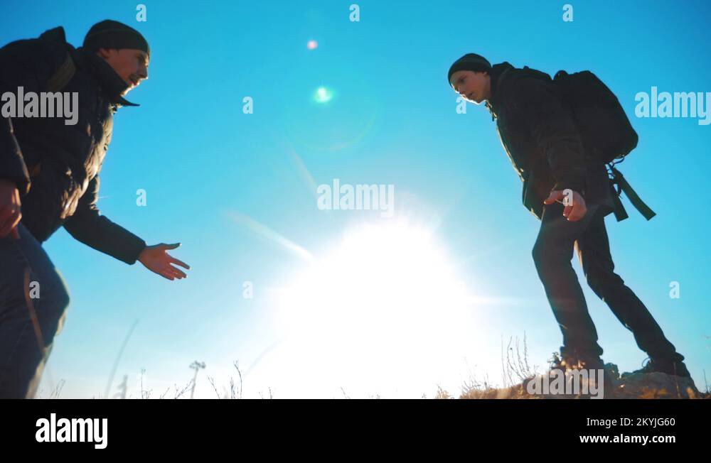 teamwork tourists business travel trip lends a helping hand. two men ...