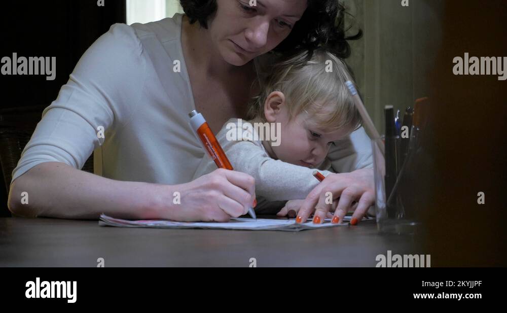 Mother Writing Letter With Baby Seated in Lap Stock Video Footage - Alamy