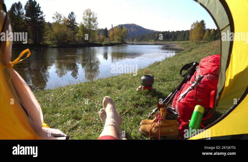 Altai. Camping woman lying in tent Close up of Girl feet wearing hiking ...