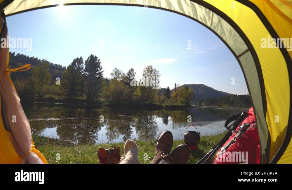 Altai. Camping woman lying in tent Close up of Girl feet wearing hiking ...