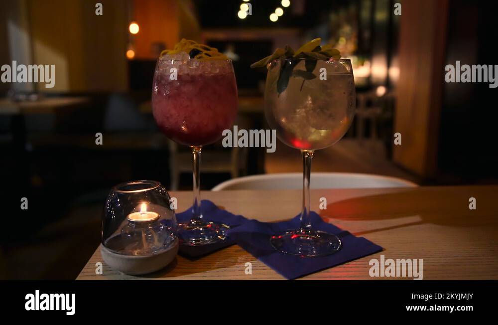 Two craft cocktail drink in a upscale cocktail lounge and a woman's ...