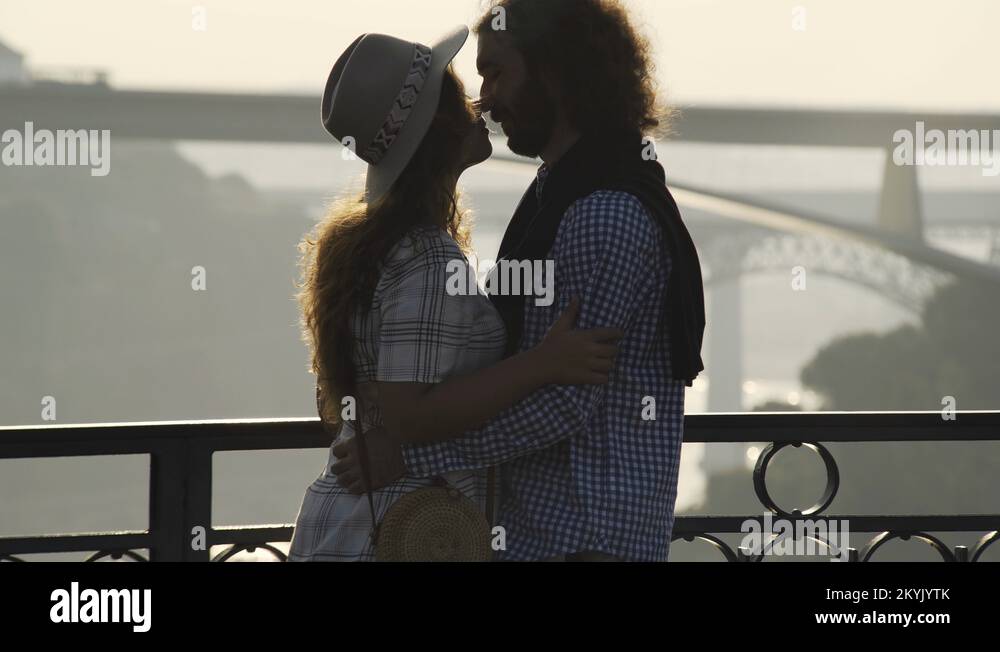 Embracing and kissing couple on high top bridge Stock Video Footage - Alamy