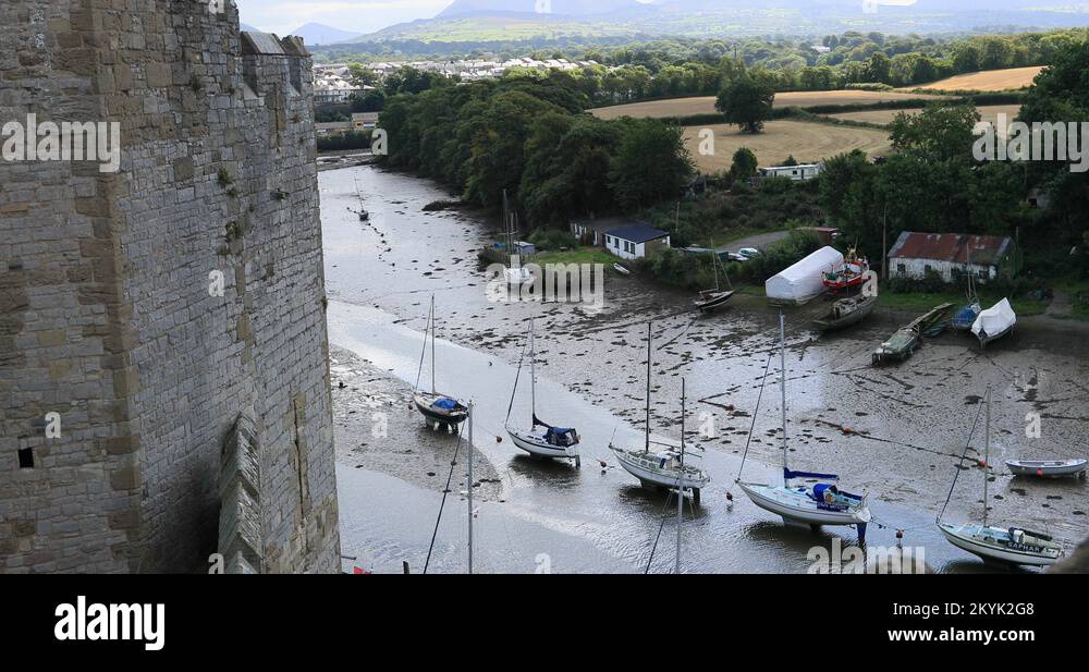 Caernarfon Castle wall low tide sail boats ocean bay Wales 4K Stock ...