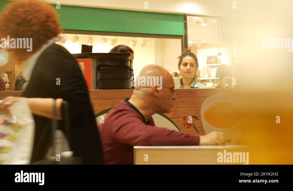 Bald Man Eating Dinner at Mall Food Court; Bald Man Eating Soup Stock ...