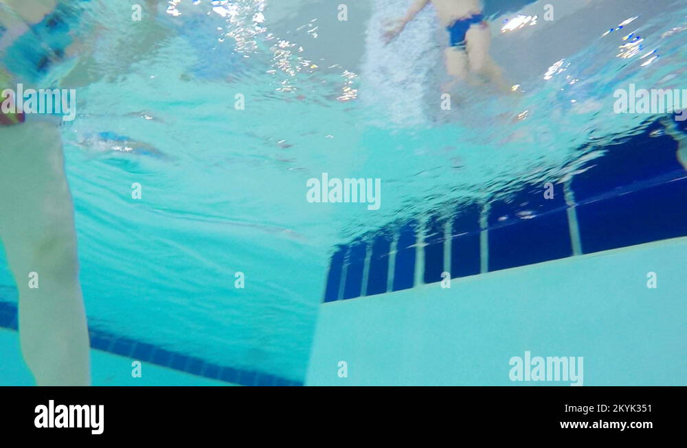 A boy dives in a pool, learning to swim underwater, close up Stock ...