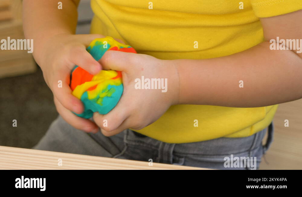 A 2-year-old preschool kid making christmas tree from modeling clay ...