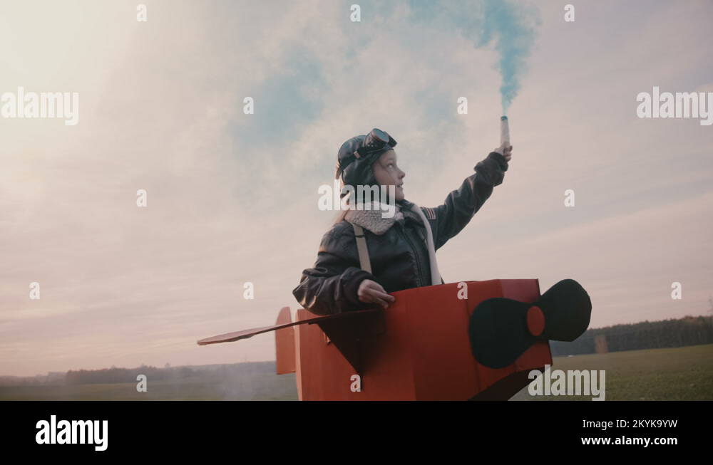 Little pilot girl running, wearing fun cardboard plane costume with ...