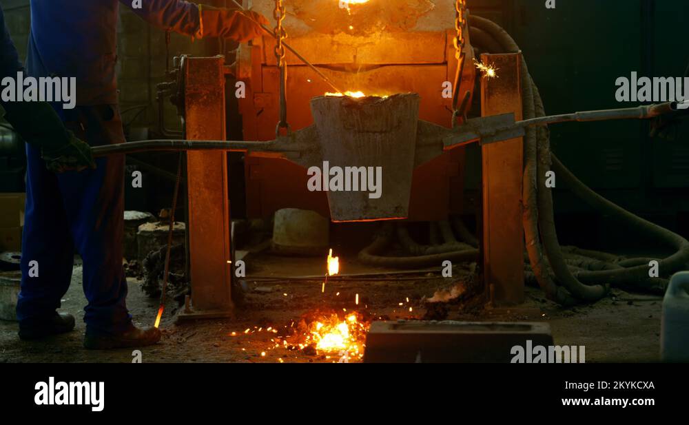 Male worker mixing molted metal in container at workshop 4k Stock Video ...