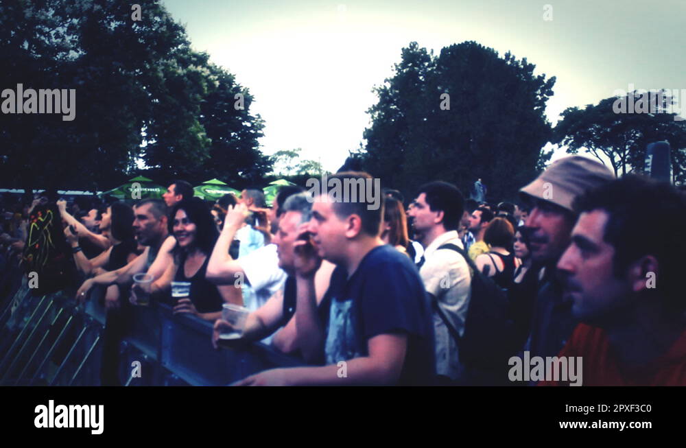 fans crowd on music festival,at the concert stage lights and dancing ...