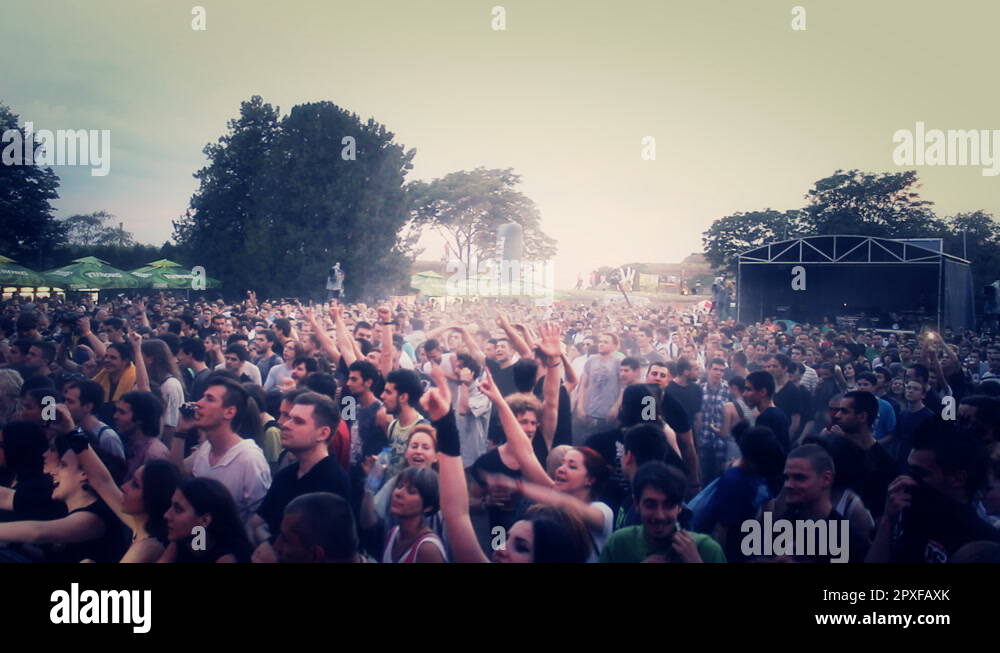 crowd on music festival,at the concert stage lights and dancing music ...