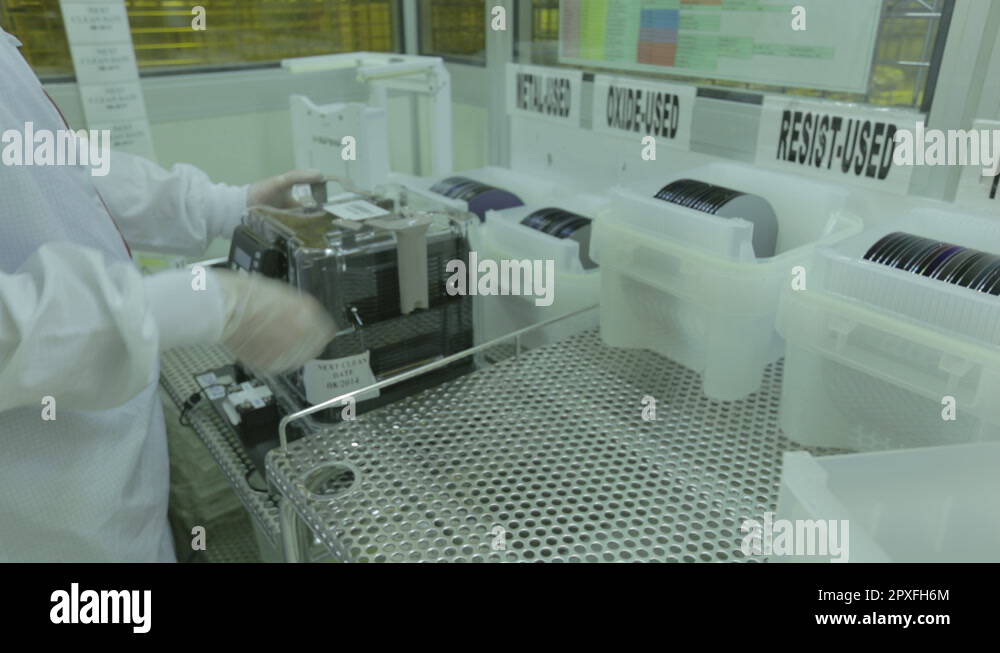 Worker examining a silicon wafer in a clean room Stock Video Footage ...