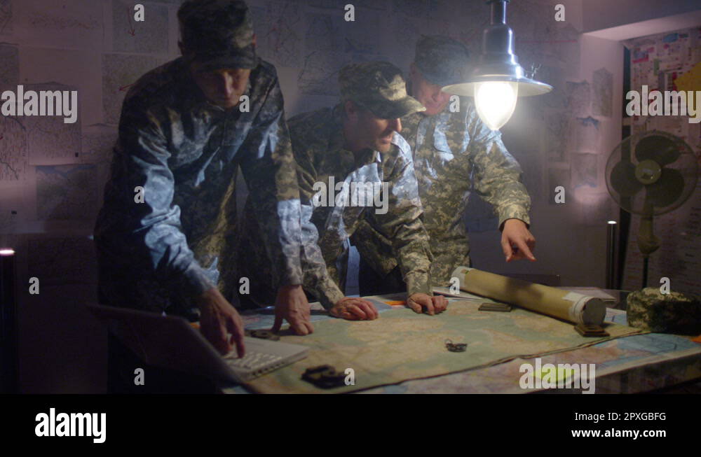 4K Military officers in army bunker, looking at map & discussing battle ...