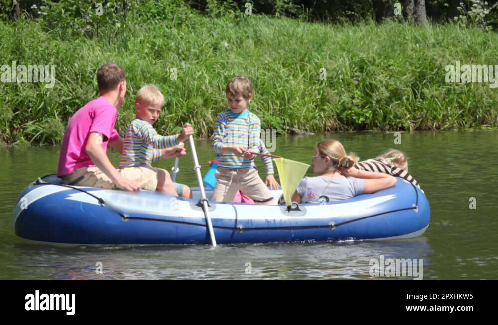 family with 4 kids in rubber boat, rowing Stock Video Footage - Alamy