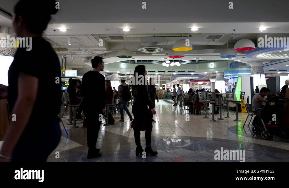 People enjoying meal in modern mall food court cafeteria with 4k ...