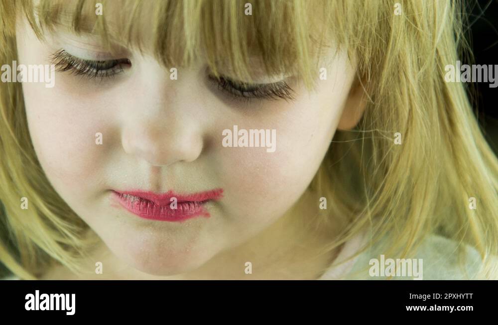 The little cute girl makes up lips with red lipstick Stock Video ...