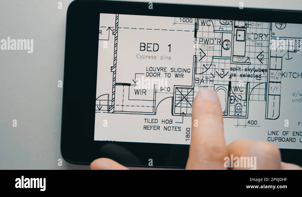 Architect moves his finger on the touchpad of the structure of the ...