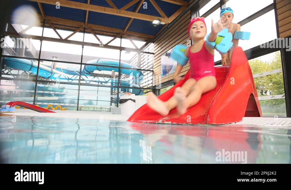 Little girl sliding on slide at the swimming pool Stock Video Footage ...