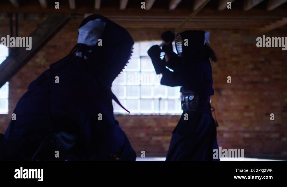 4K Japanese kendo fighters with bamboo swords competing in dark ...