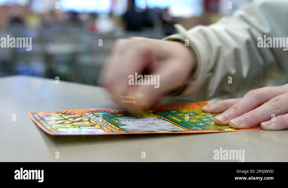 Close up woman scratching lottery ticket called cash blast inside ...