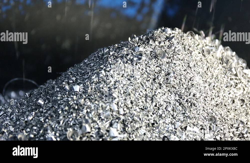 Chip conveyor moving steel chips from coolant tank to the scrap bin ...