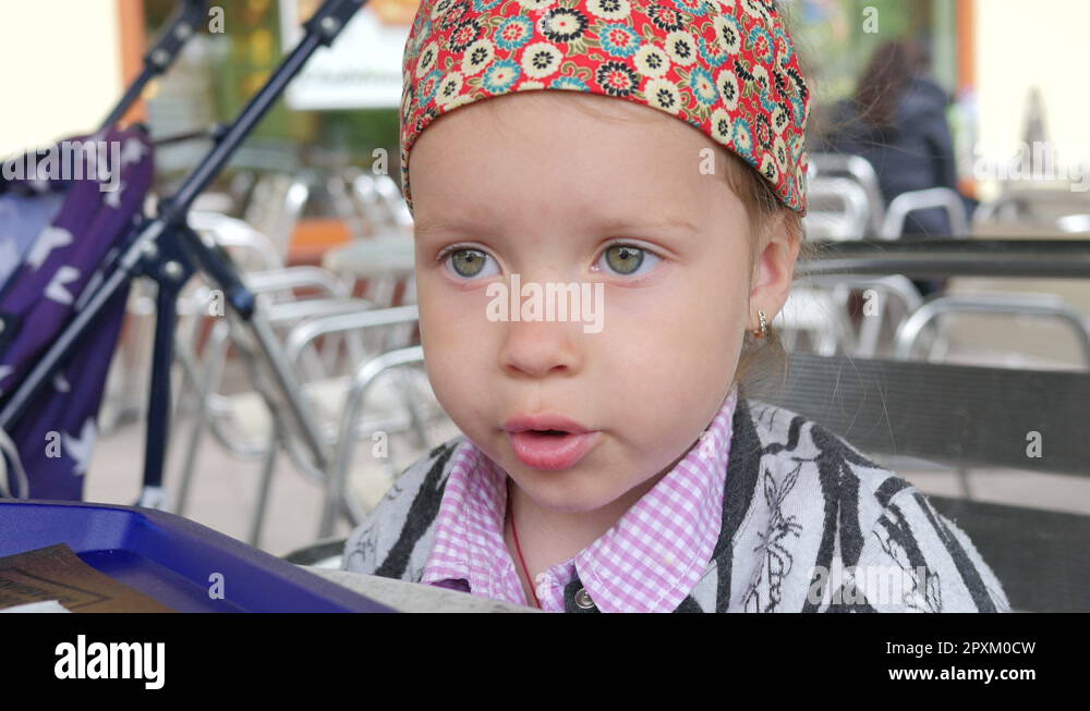 Little child kid girl eating french fries potato with hands fast food ...