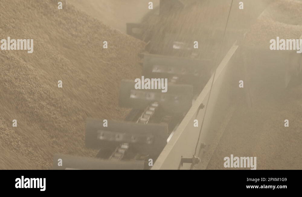 Scraper loader delivers grain, screw conveyor to load Stock Video ...