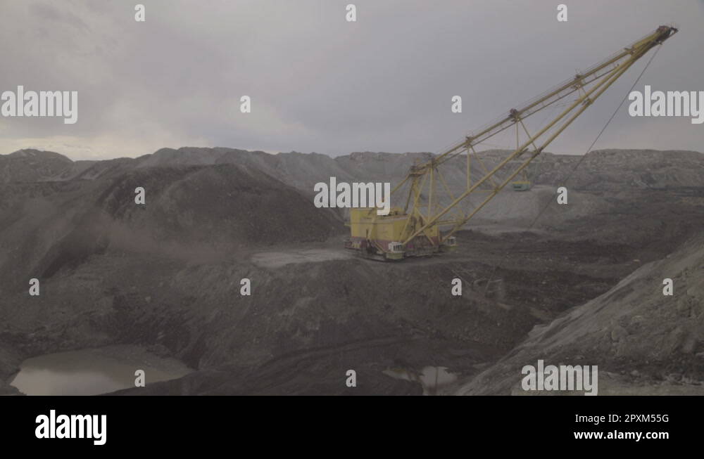 A dragline excavator working on development of open fields Stock Video ...