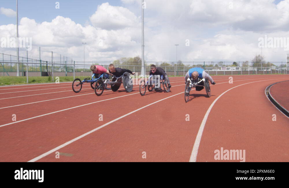 4K Disabled wheelchair athletics team competing in a race at race track ...