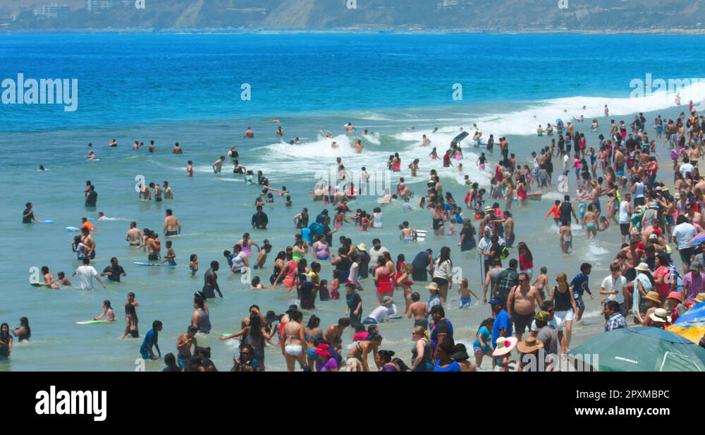 Crowd of people swim in the Pacific Ocean in Santa Monica Beach, Los ...