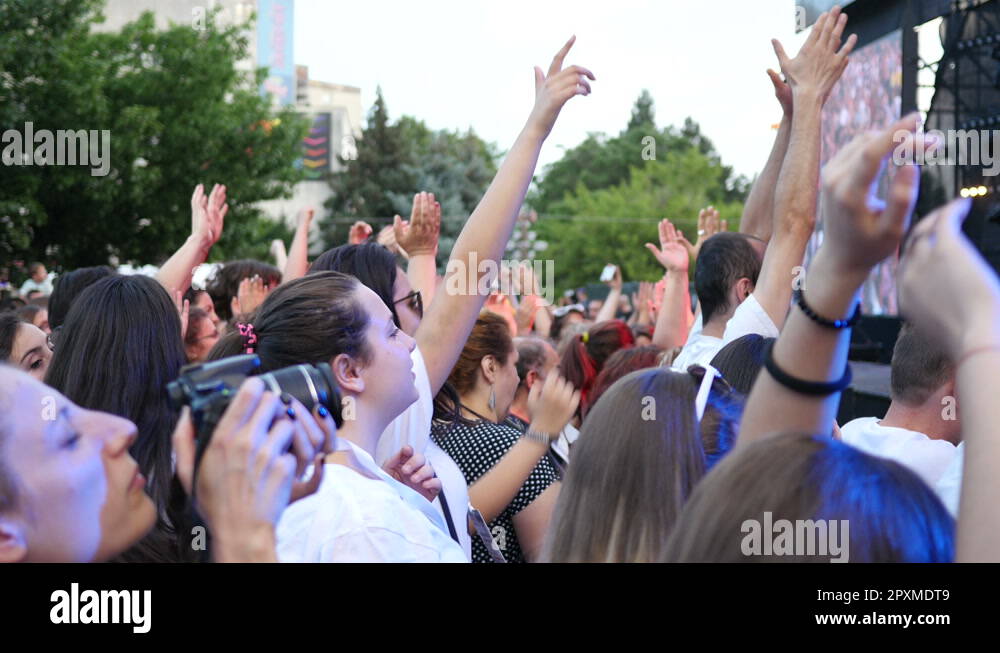 People crowd jumping dancing clapping hands in front of stage on music ...