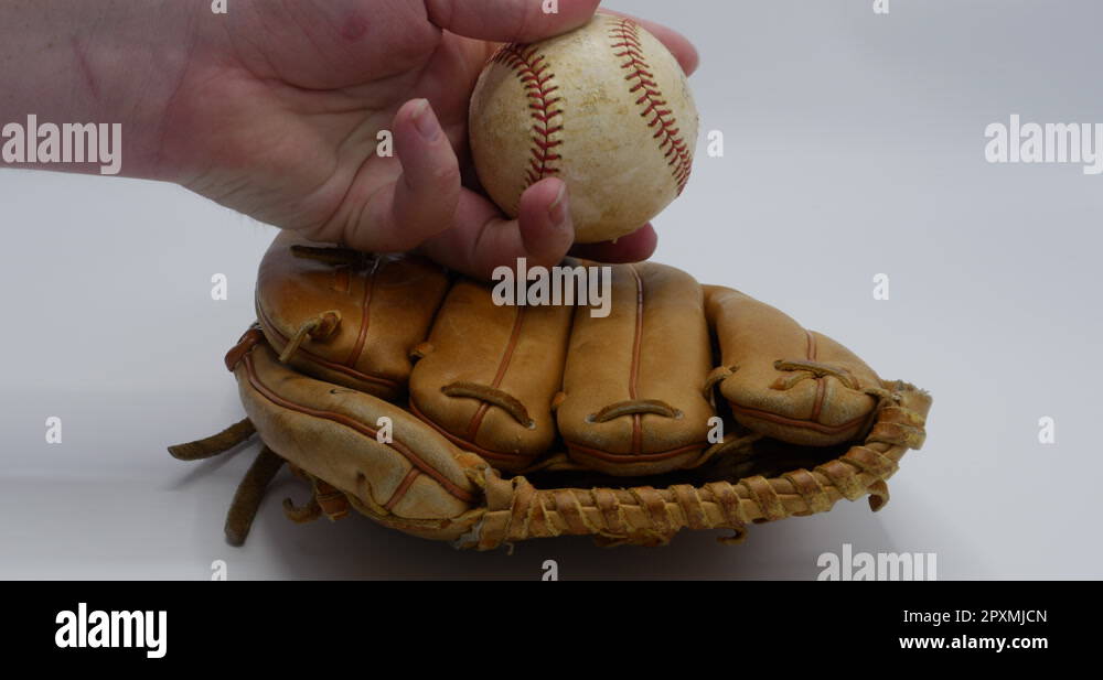 Pick Up Baseball on Old Mitt Remembering the Game on White, 4K Stock ...