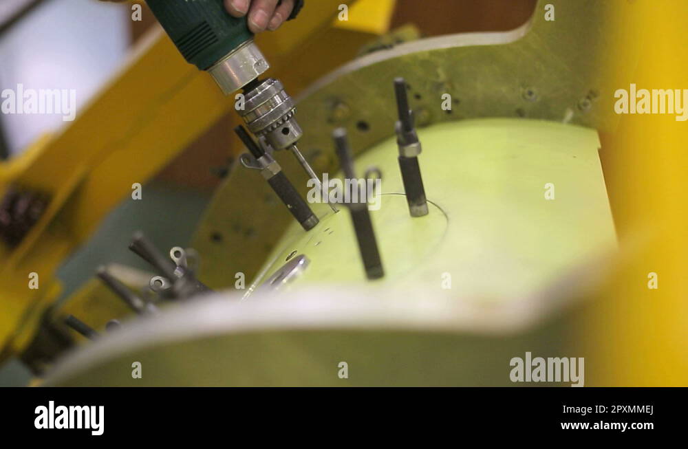Drilling holes in body parts of aircraft and install bolts tightening ...