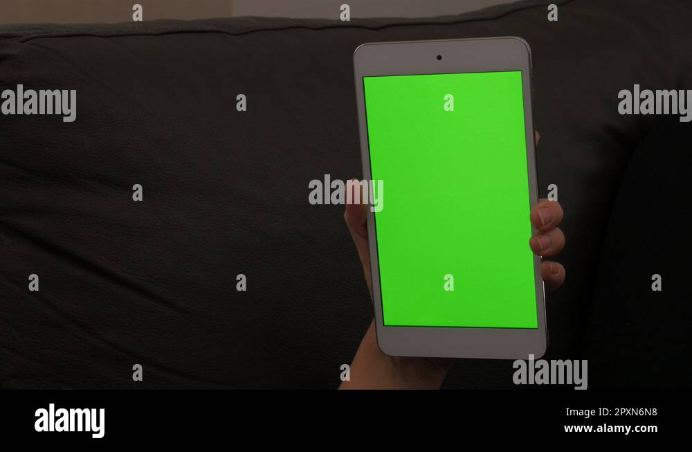 Resting at home woman and holding green screen chroma key tablet 4K ...
