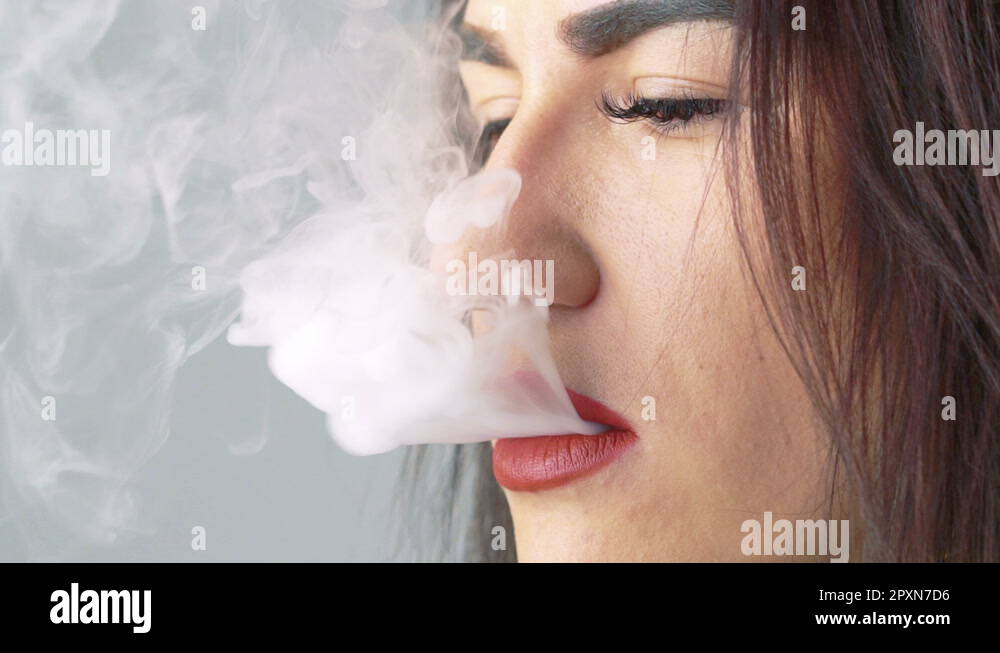 Profile of woman face blowing fume on beige background. Slowly Stock ...