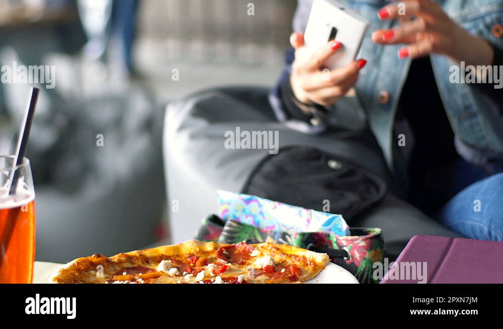 Hipster girl doing photo of pizza in the restaurant, steadycam shot ...