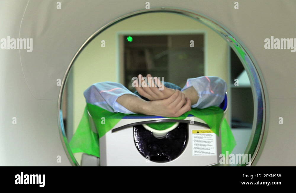 An MRI scanner in working process with patient on rolling desk Stock ...