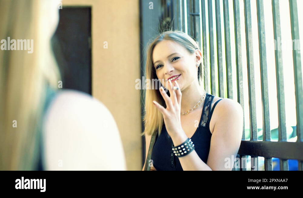 Punk girl smoking cigarette and talking with her friend Stock Video ...