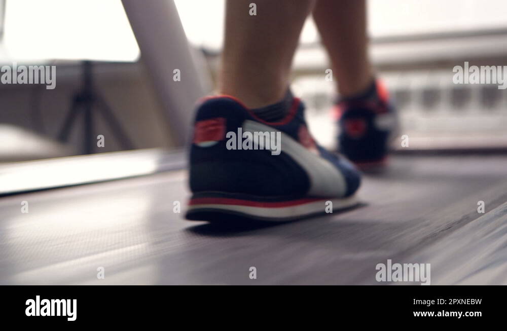 Female legs walking and running on treadmill in gym. Healthy lifestyle ...
