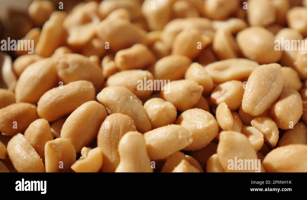 Roasted groundnut snack food slow tilting background 4K 2160p UltraHD ...