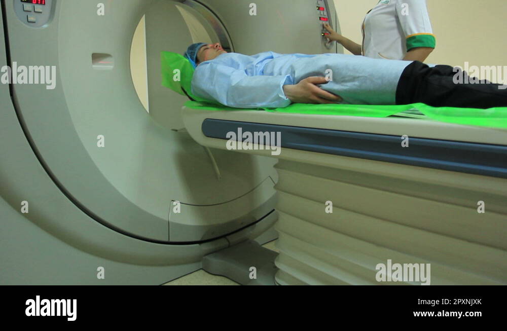 A Lady-Doctor launches an MRI scanner with a patient inside to scan his ...