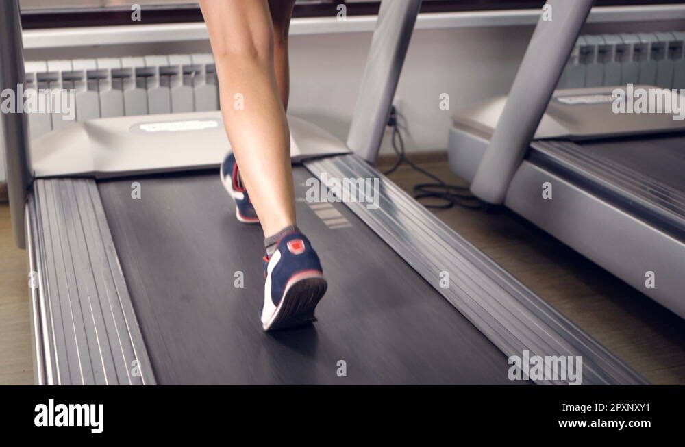 Female legs walking and running on treadmill in gym. Healthy lifestyle ...