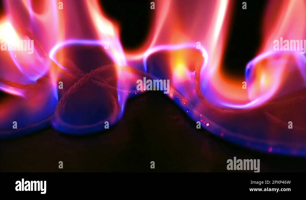 Blue and red flame background in dark. Burning liquid looks like a ...