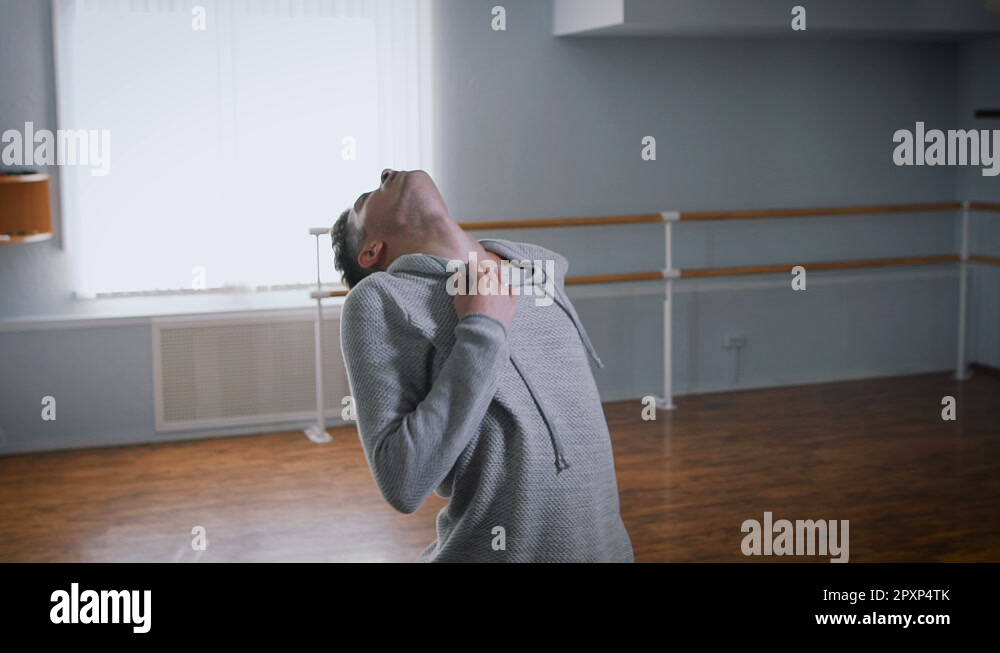 Young professional dancer performs contempo dance in large dance studio ...