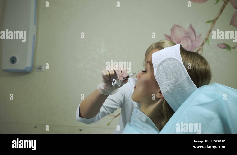 Correction of shape of a nose. The doctor checks the line of girl's ...