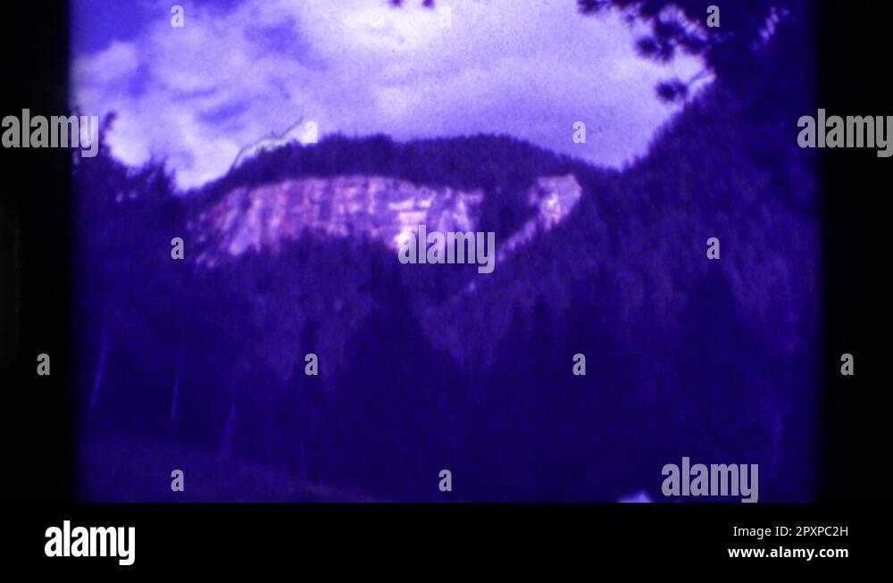 1975: exposed rock face surrounded by forest and valley below AGATE ...