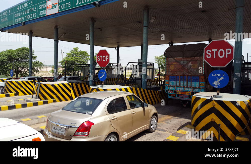 Truck and car cross Indian highway freeway toll gate checkpoint, India ...