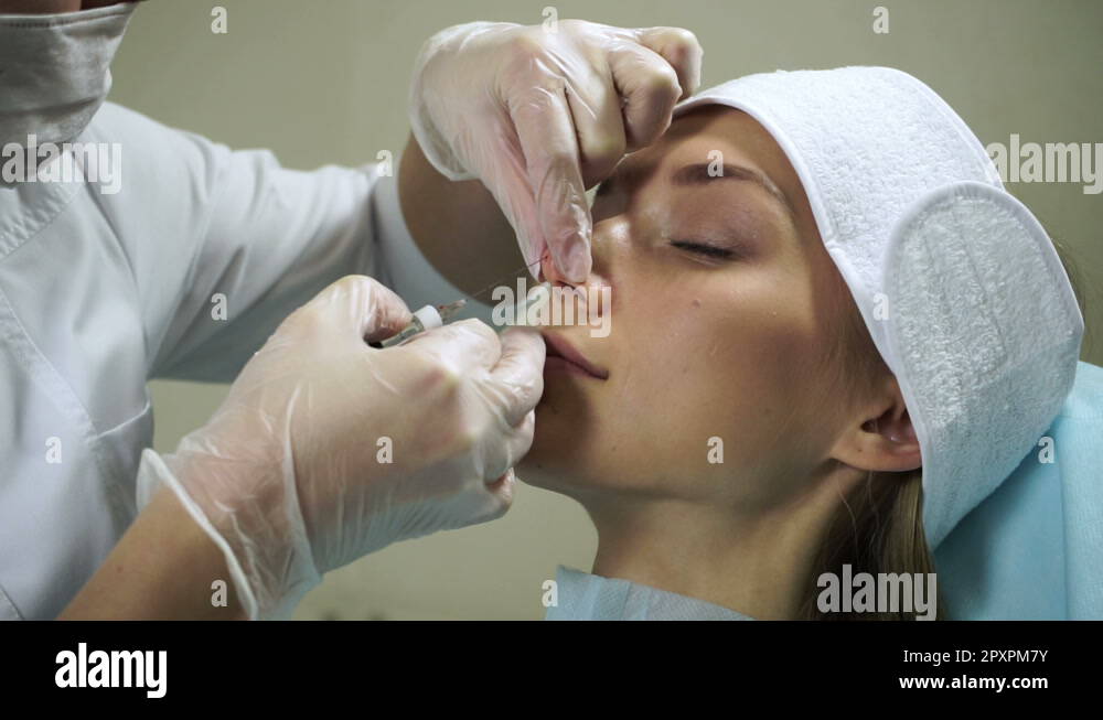 Non-surgical correction of shape of a nose. A young girl during a ...
