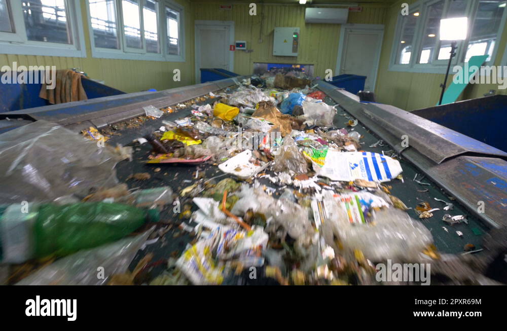 Trash, rubbish, litter on a working sorting conveyor belt in a recycling plant Stock Video ...